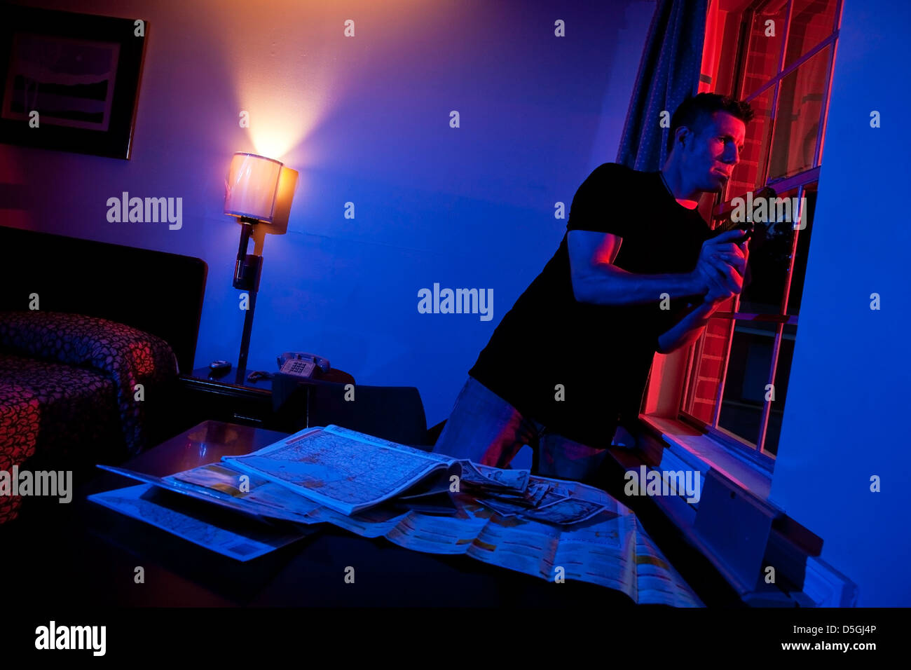 Man at window with gun Stock Photo - Alamy