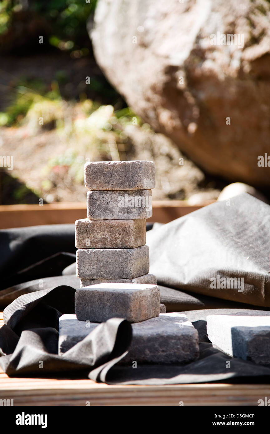 Building a patio with wooden terrace and stones Stock Photo - Alamy