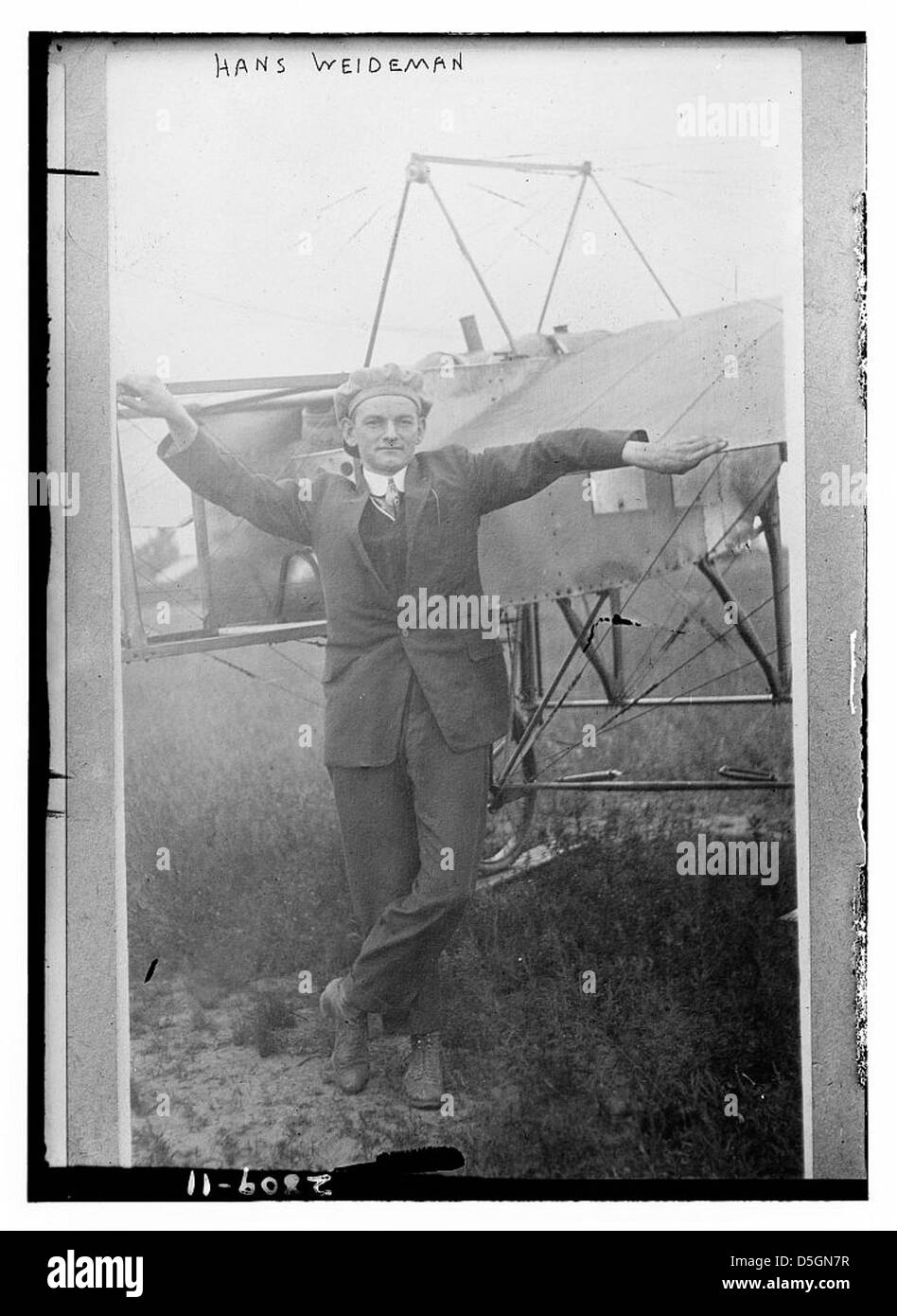 Portrait of Hans Weidman with an early monoplane, showcasing early ...