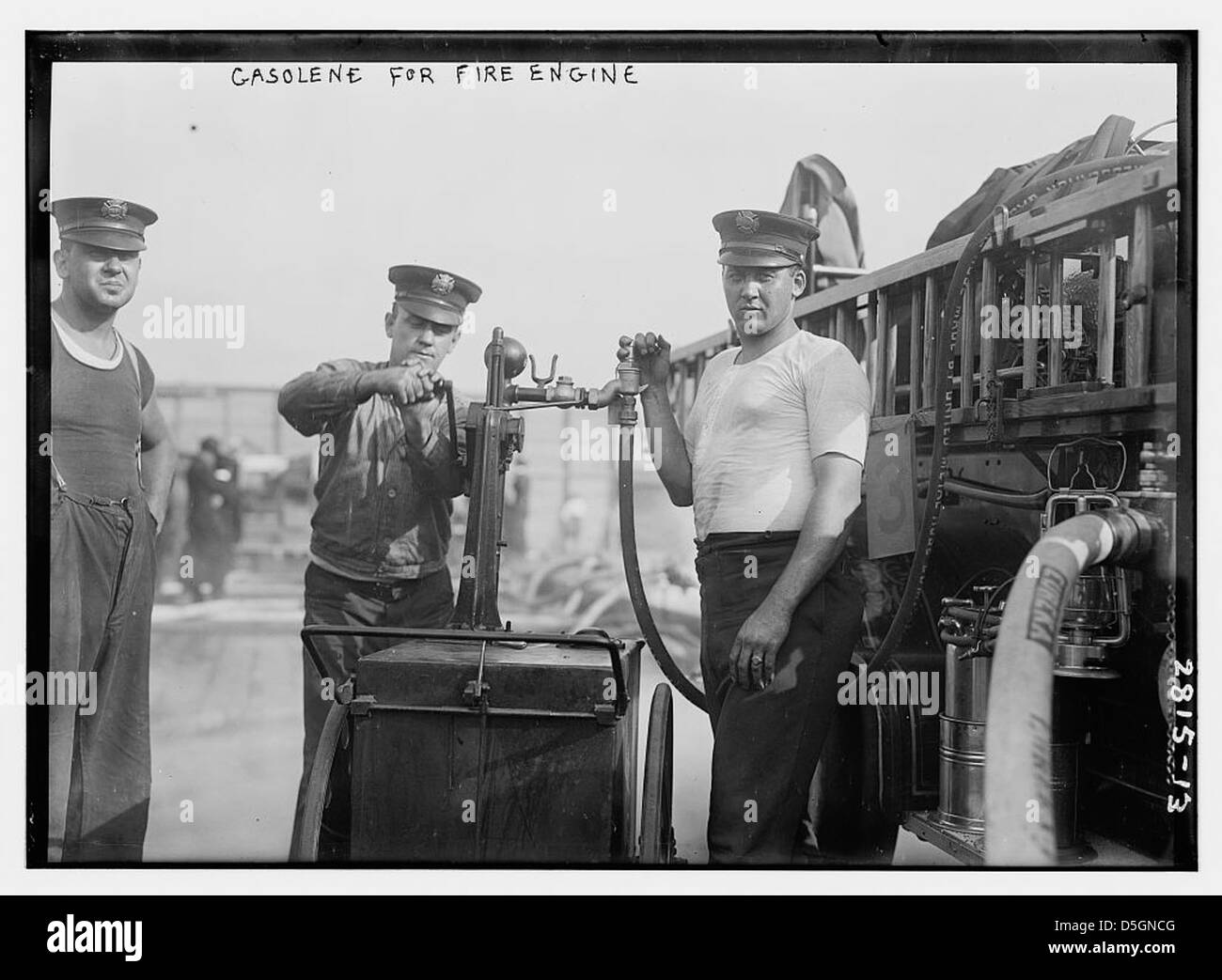 A 1913 image of firefighters fueling a fire engine with gasoline. The ...