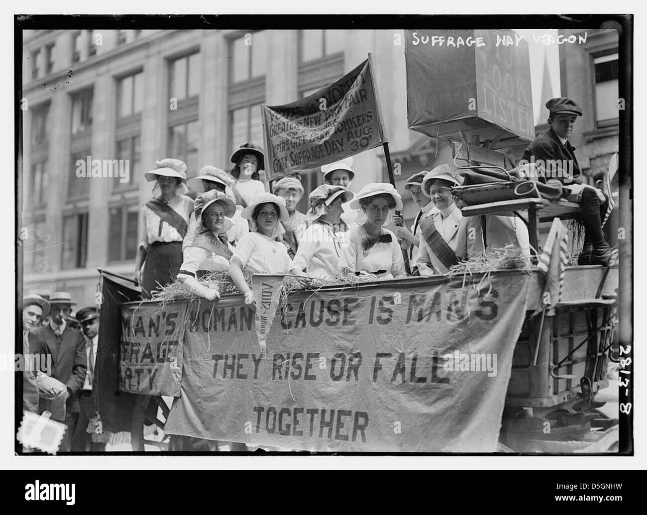 A historical image from a suffrage parade showing a hay wagon adorned ...