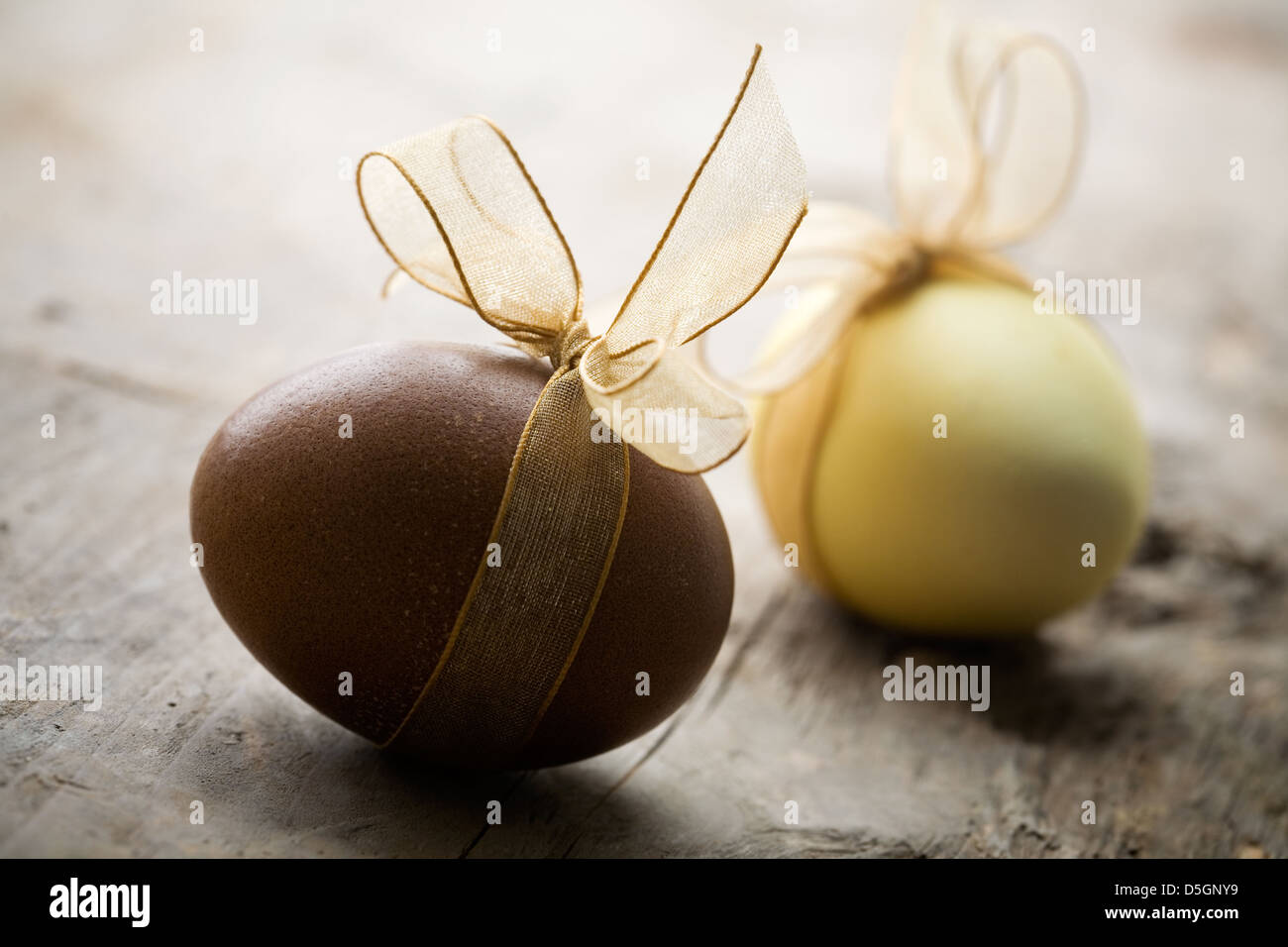 Two easter eggs with beautiful golden bow Stock Photo - Alamy