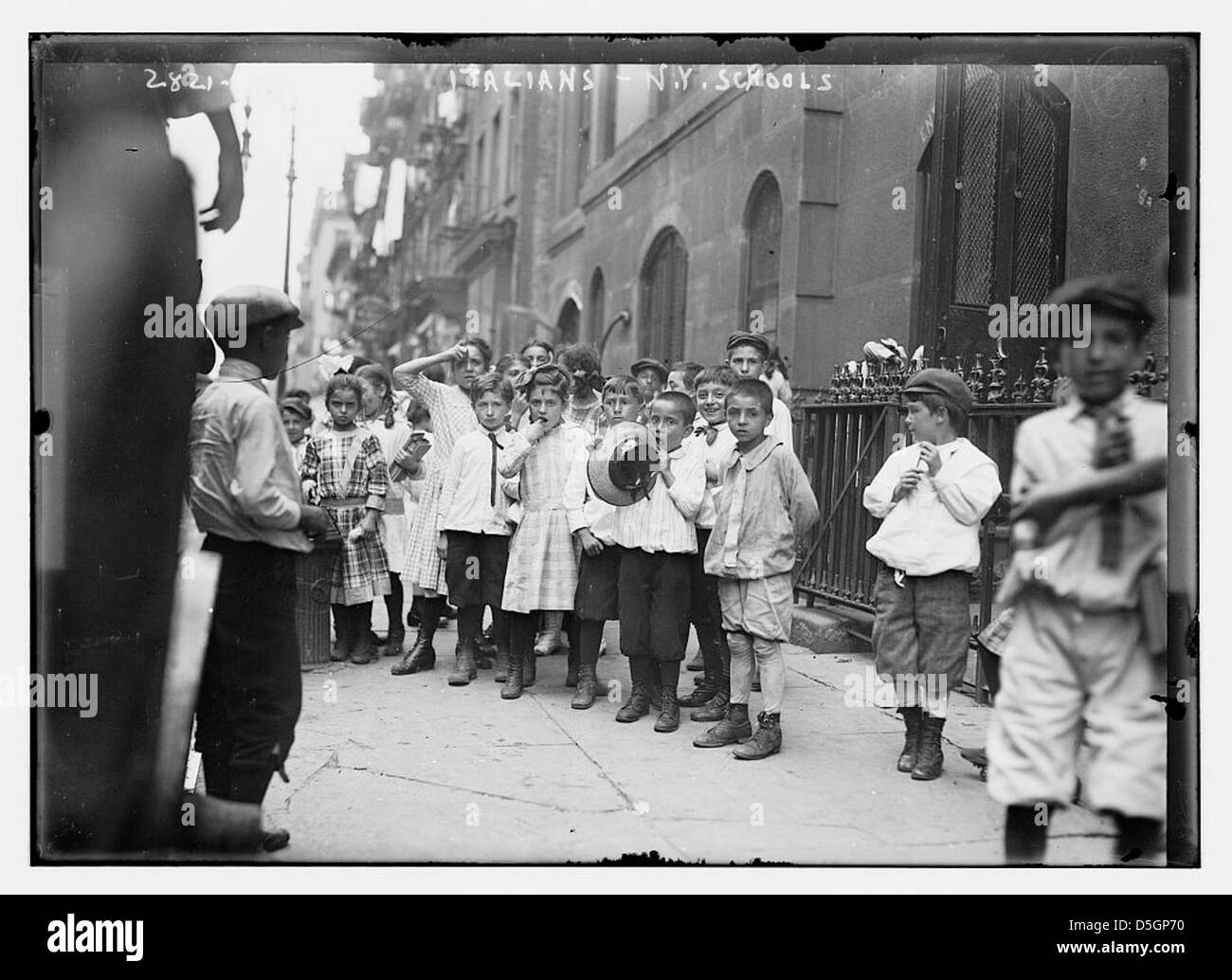 This black-and-white photograph from the 1910s depicts Italian children ...