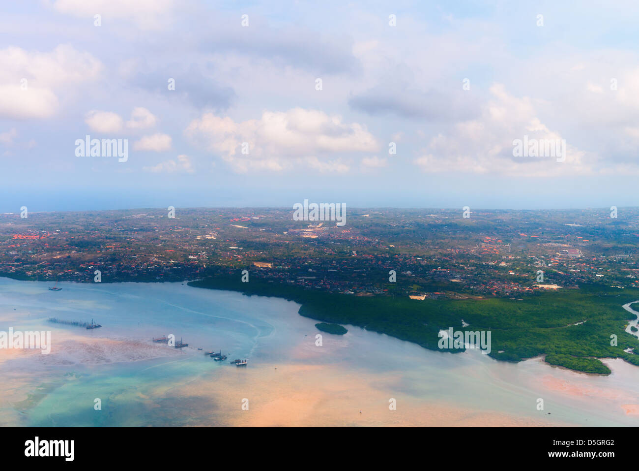 Aerial view of Denpasar on Bali showing buildings andmangrove forest ...