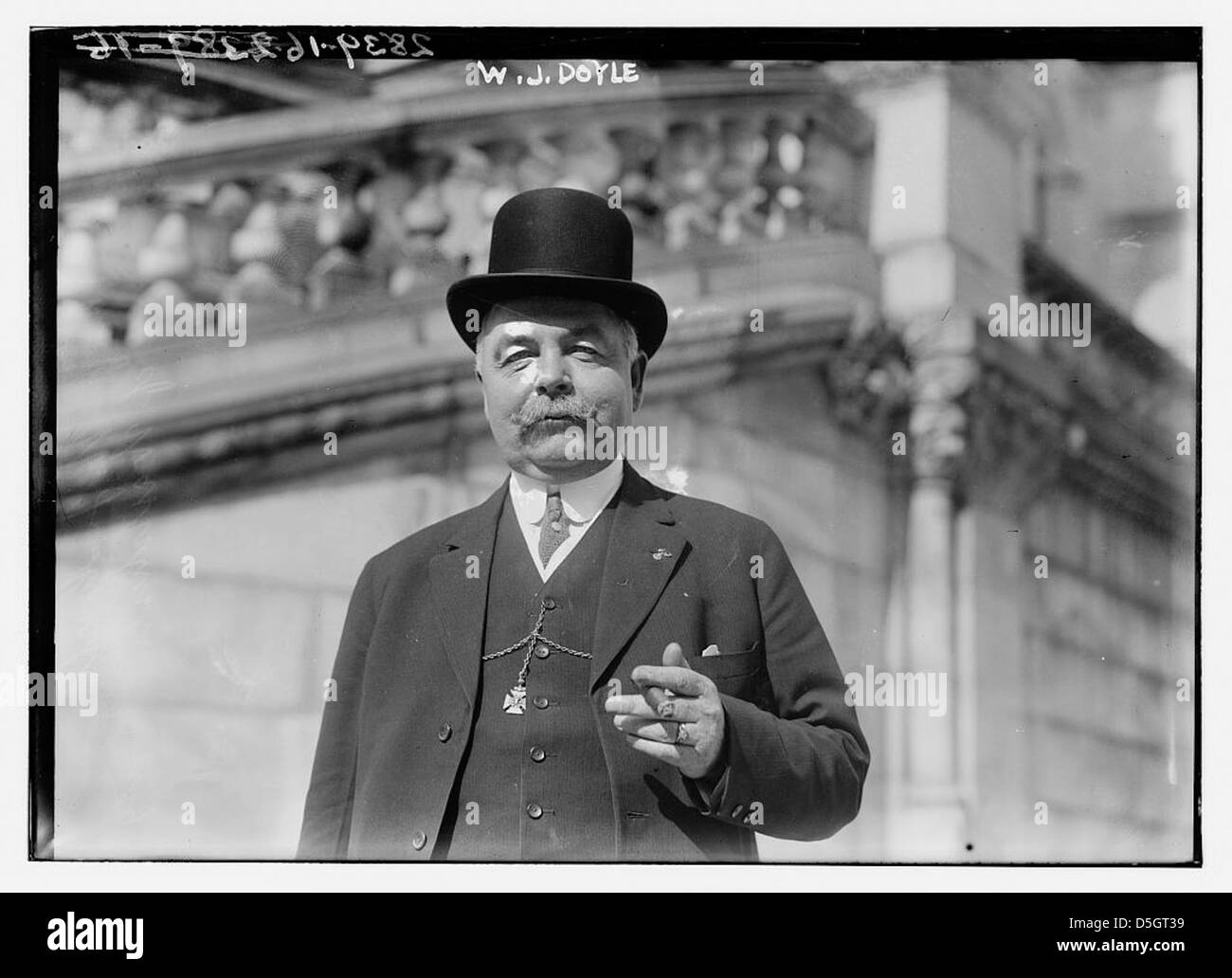 Photograph of W.J. Doyle wearing a bowler hat, smoking a cigar, with a ...