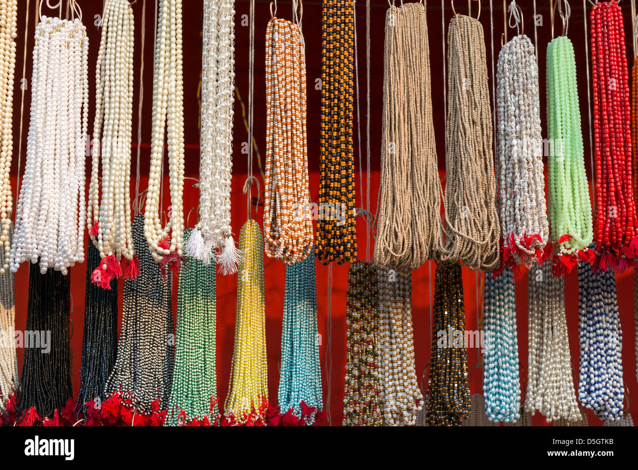 Strands of small colorful beads at the outdoor craft open market in ...