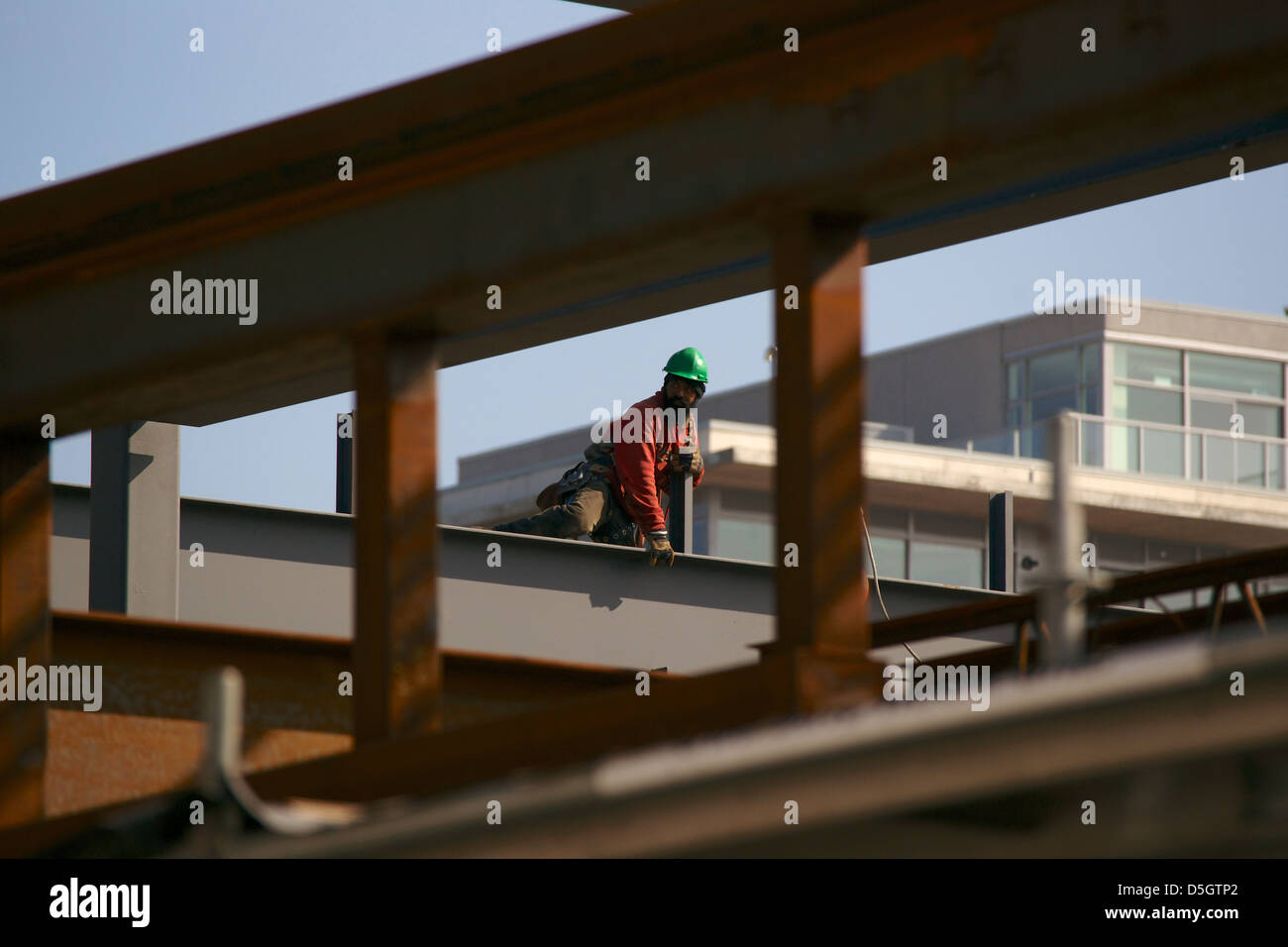 Ironworker on steel beams during construction of a building Stock Photo ...