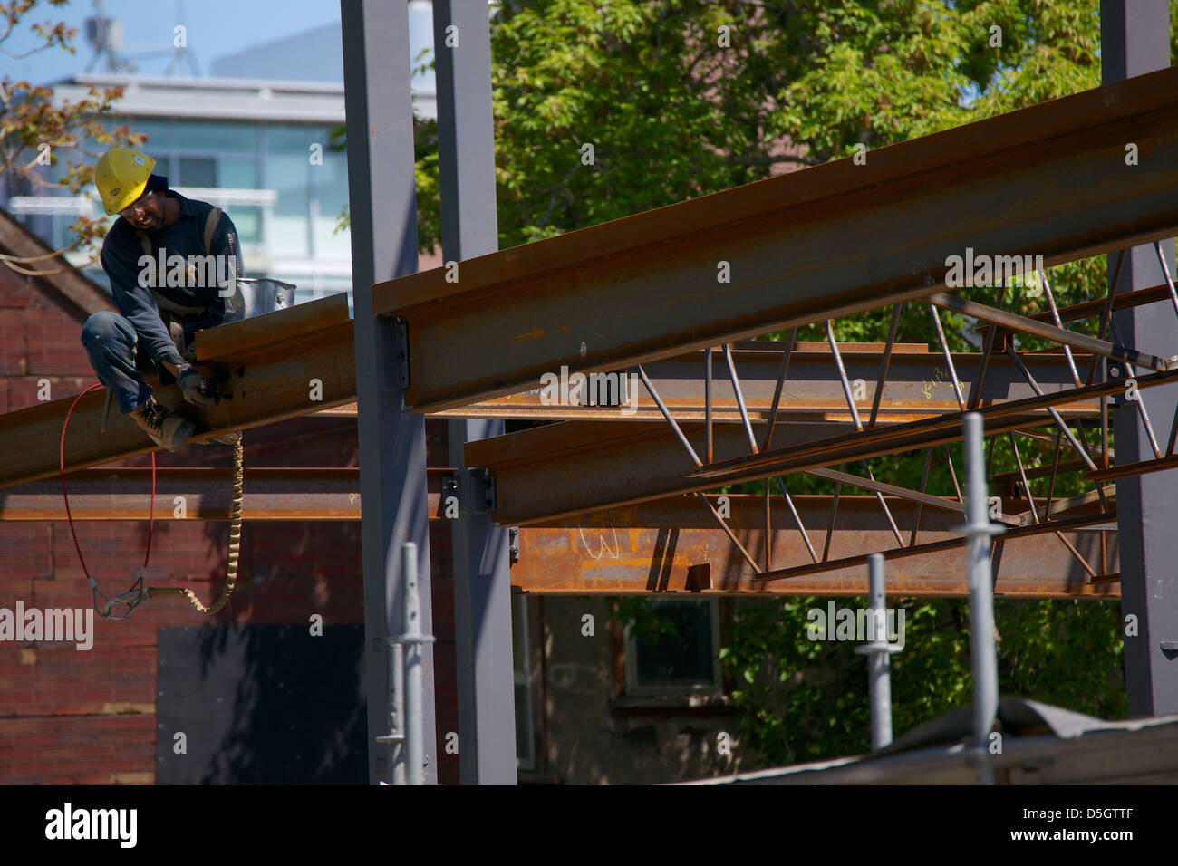 Ironworker connecting steel beams during construction of a building ...