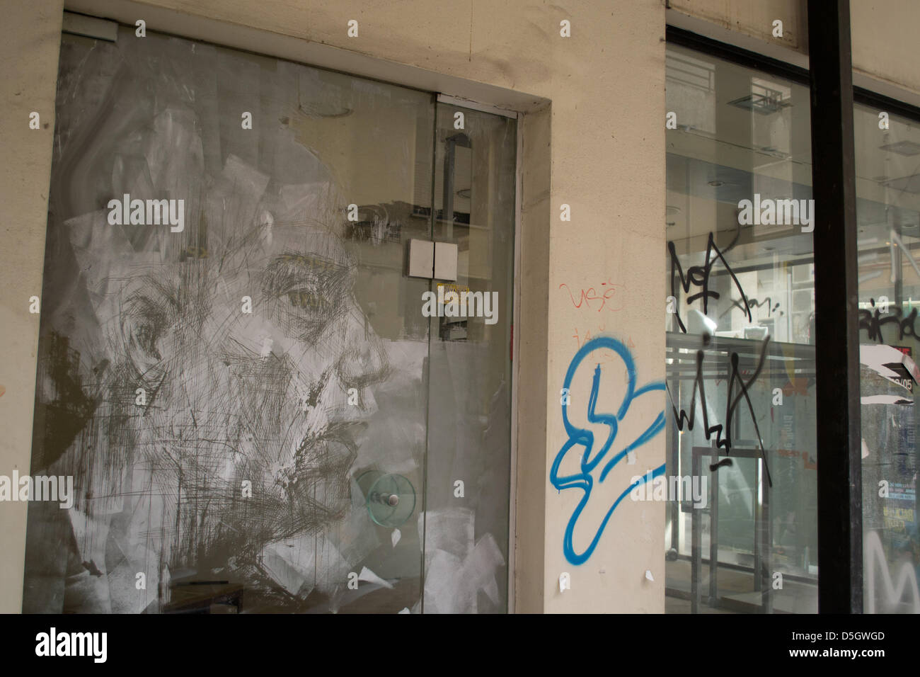 Graffiti on a closed shop storefront Stock Photo - Alamy