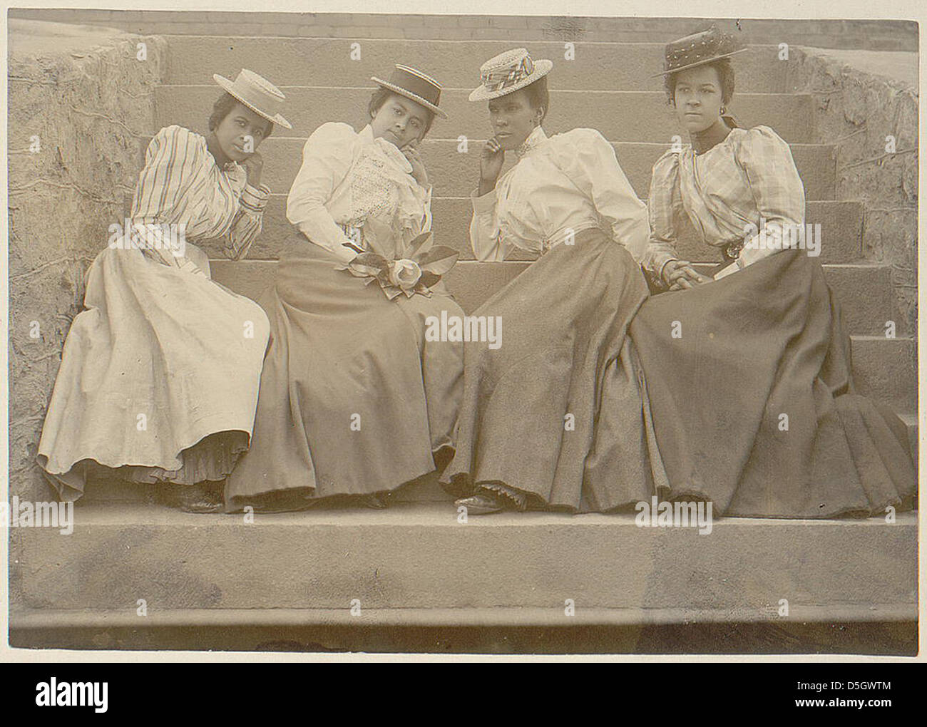A photograph from 1900 depicting four African American women seated on ...