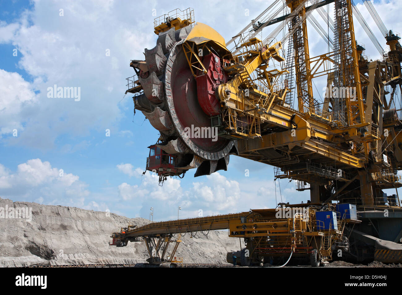 yellow big steel excavator in coal mine Stock Photo - Alamy