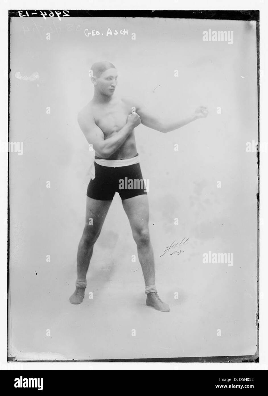 A portrait of George Asch, a boxer, posed in a boxing stance ...