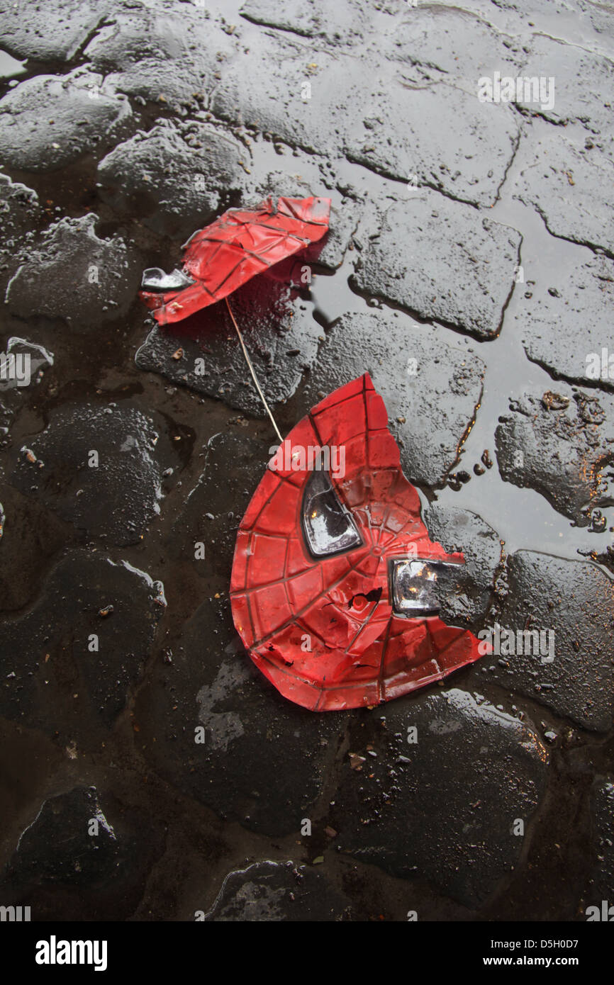 broken spiderman plastic mask on wet road in city town Stock Photo - Alamy