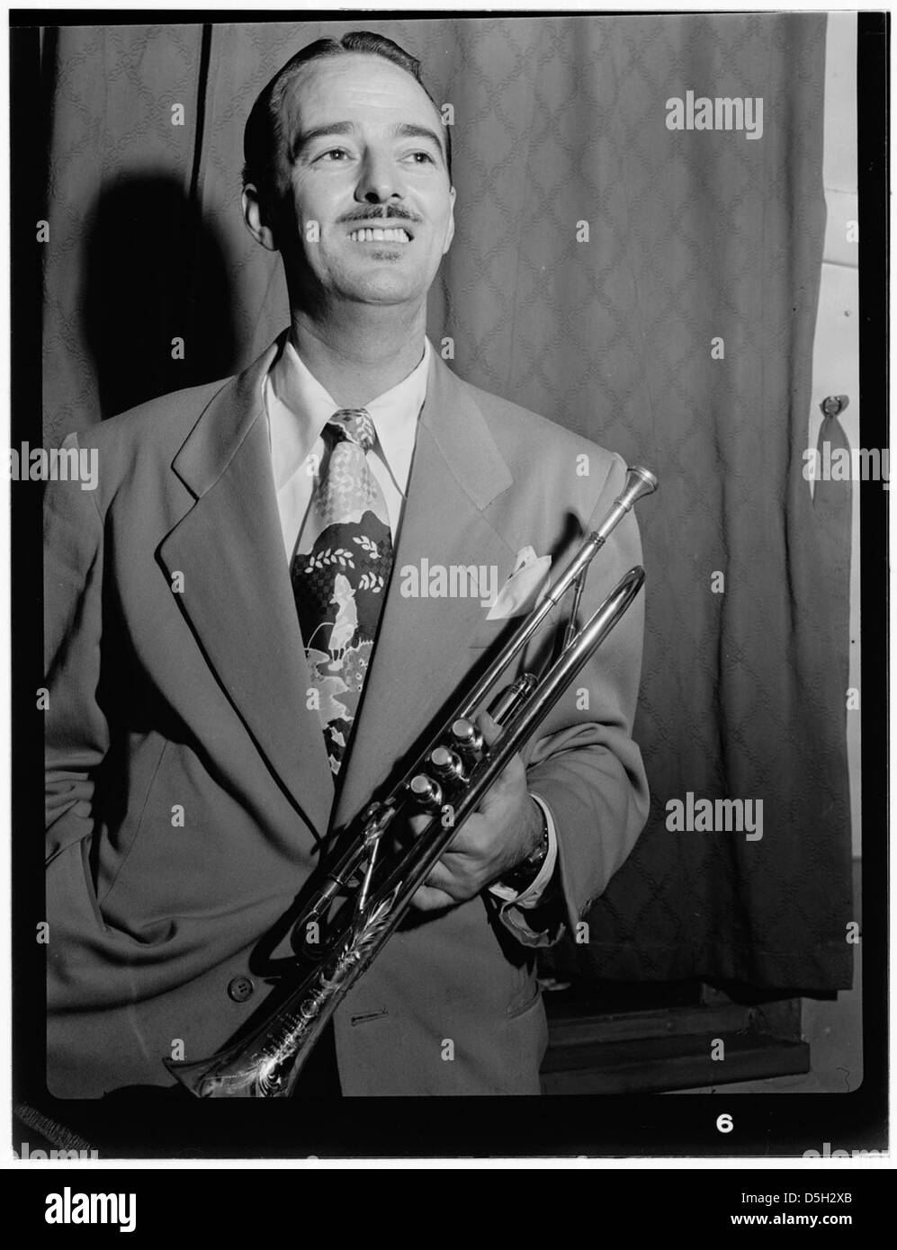Bobby Hackett, a prominent jazz cornetist, is captured in a portrait at ...