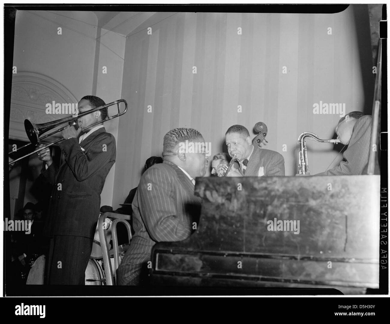 A 1940s photograph capturing jazz musicians Jay Higginbotham, Pete ...