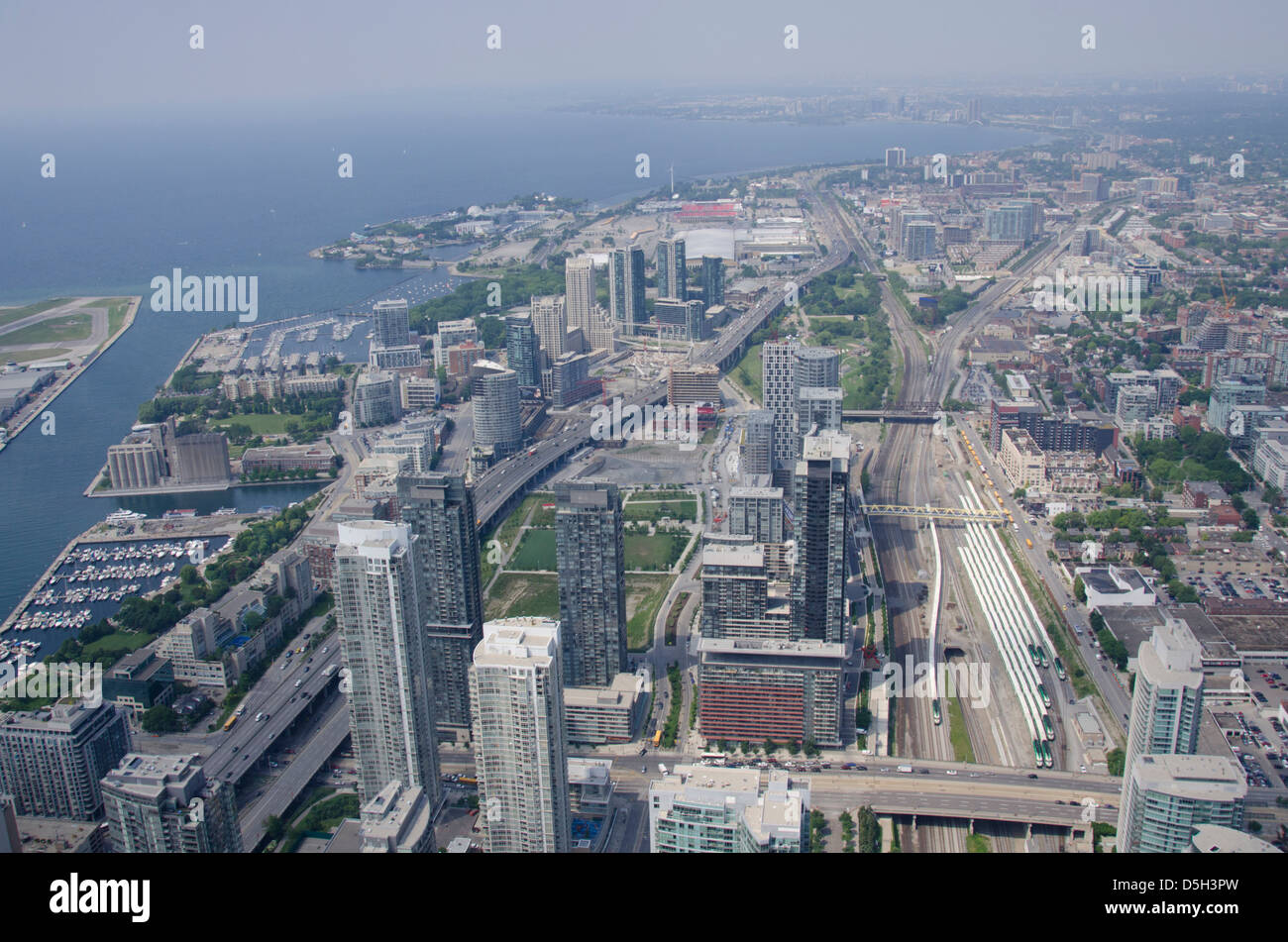 Canada, Ontario, Toronto. Lake Ontario, railroad tracks, and city ...