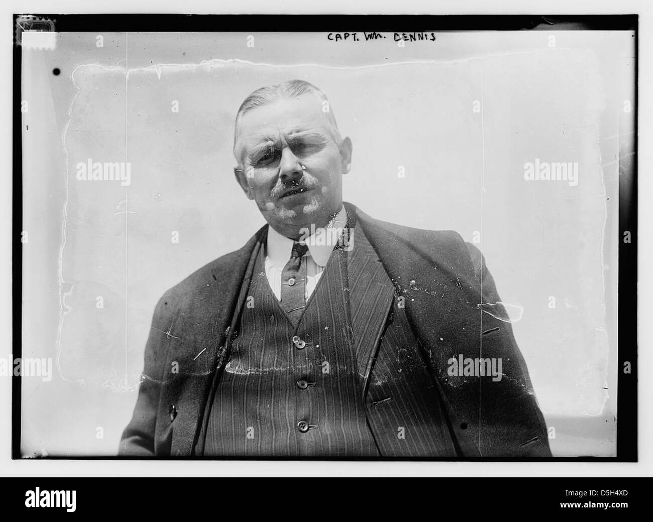 Captain Wm. Dennis is shown in a formal portrait, wearing a military ...