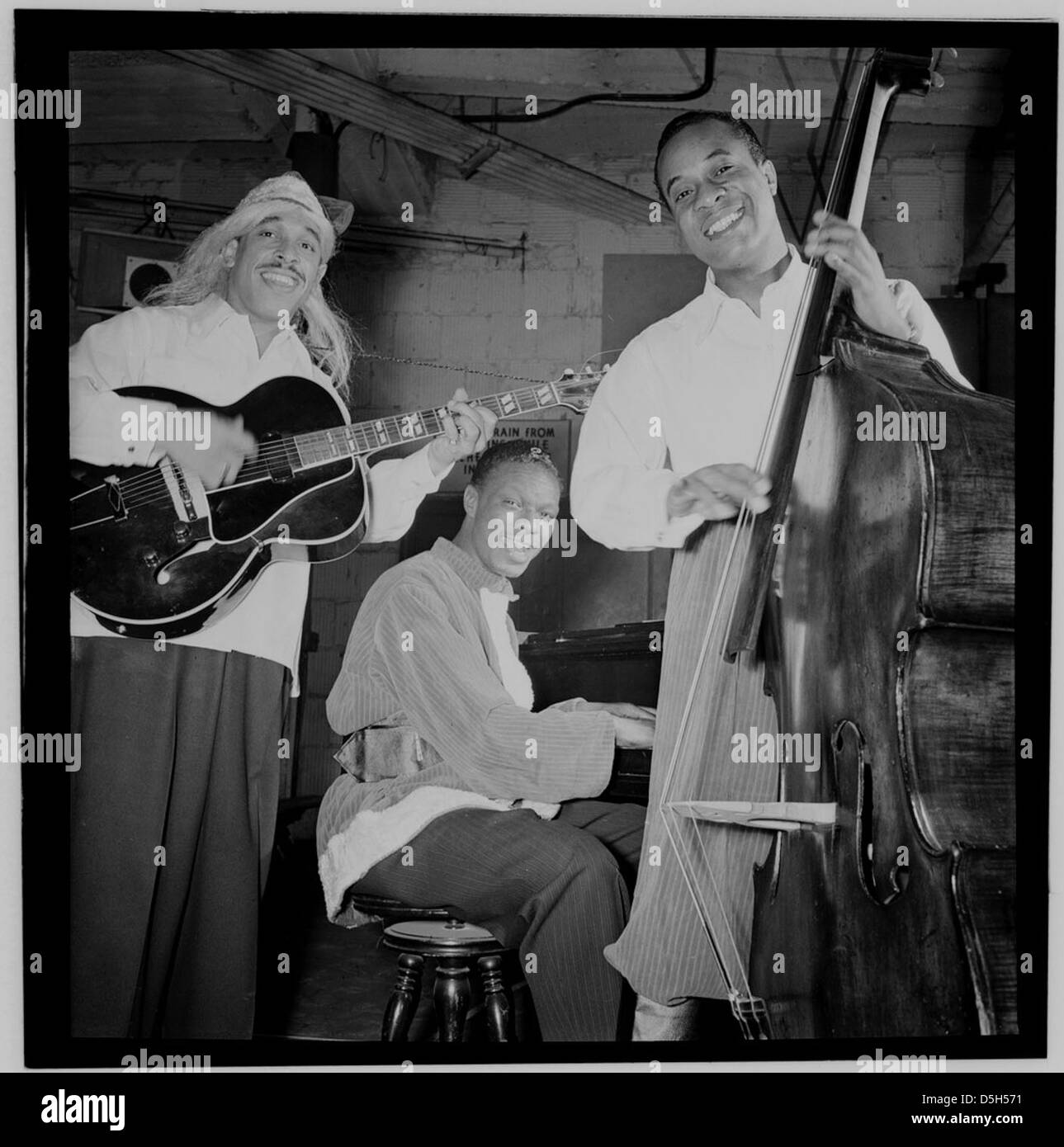 This photograph features jazz musicians Oscar Moore, Nat King Cole, and ...