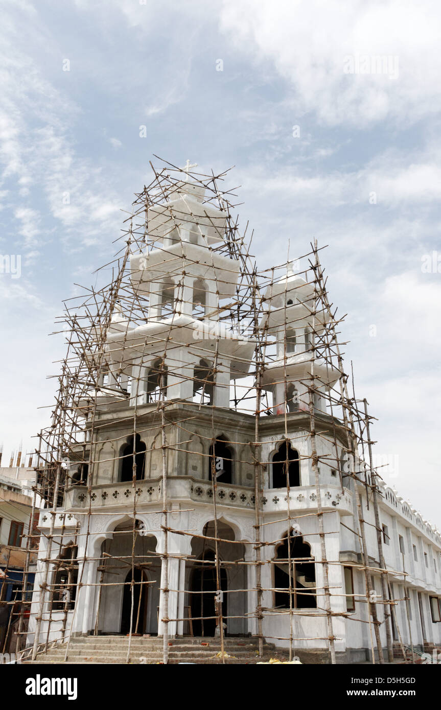 A church in India covered with very dodgy looking bamboo scafolding ...