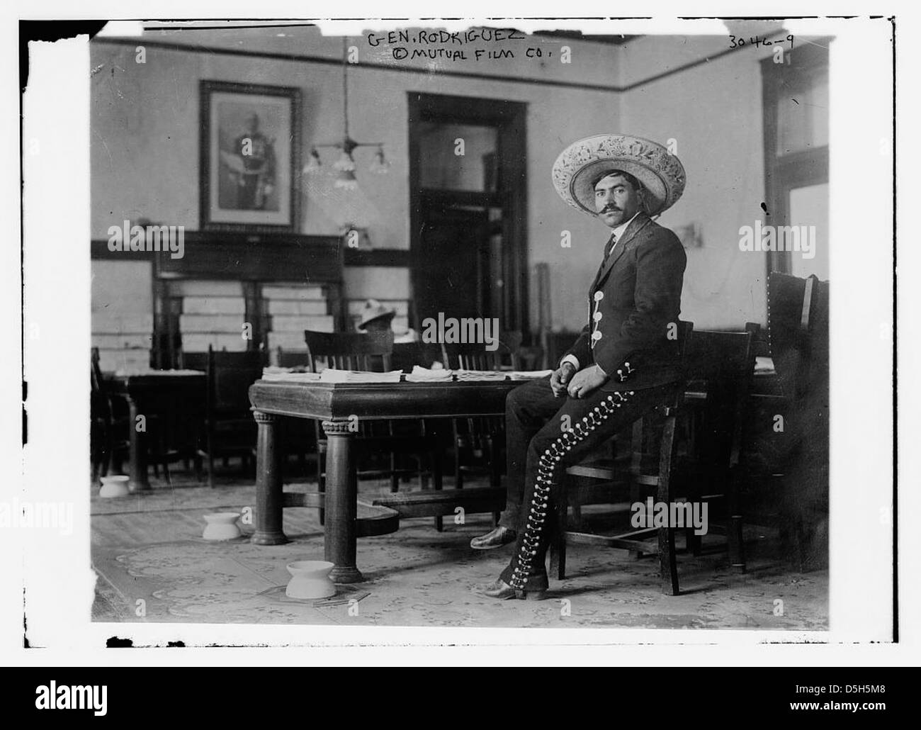 General Rodriguez is depicted in a formal portrait, seated in a ...