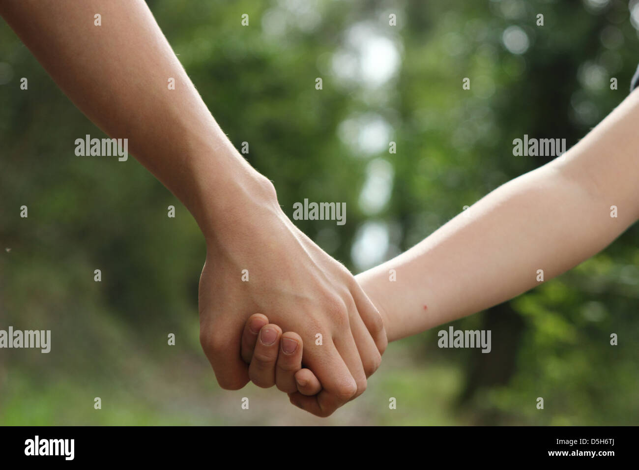 Two kids walking hand in hand hi-res stock photography and images - Alamy