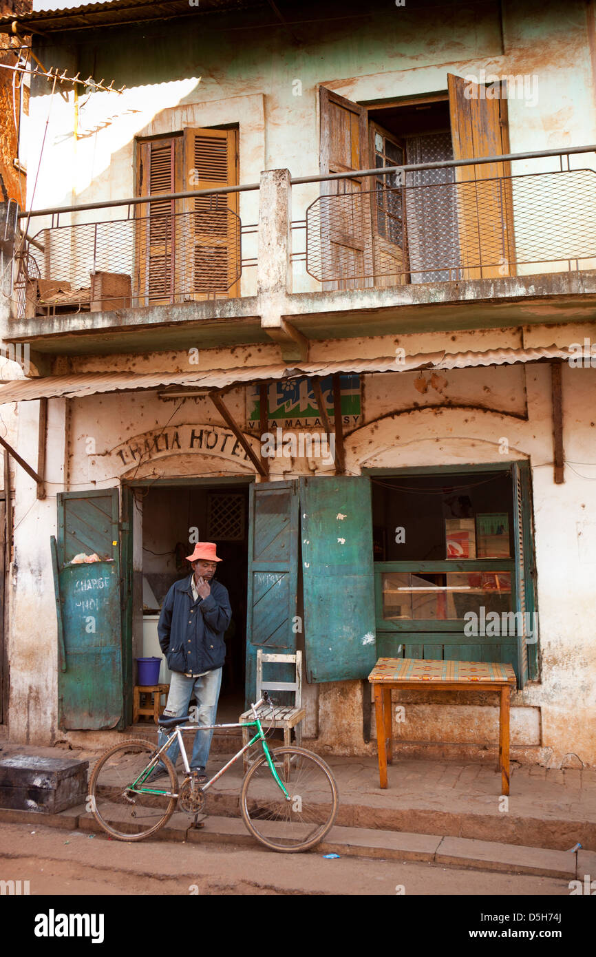 Madagascar, Ambalavao, man with bicycle outside small local hotel Stock ...