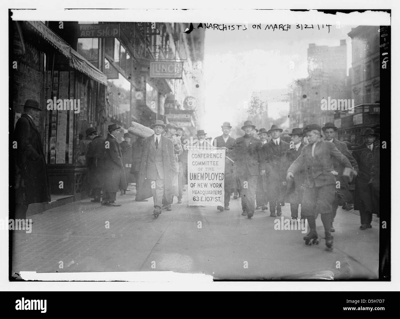 A photograph of anarchists marching with a banner in a protest ...