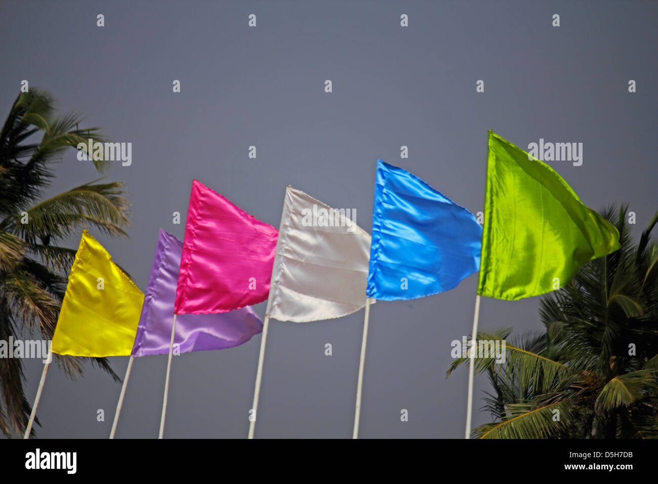 Colored flags flapping in the wind on a beach Stock Photo - Alamy