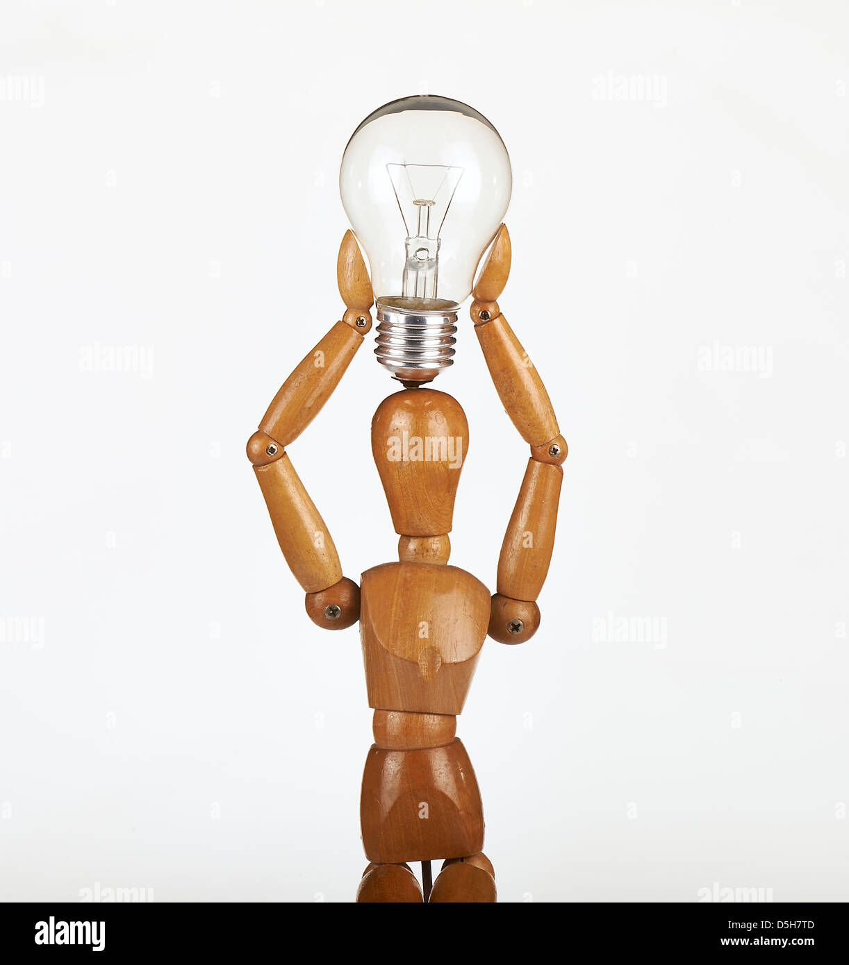 wooden dummy thinking with idea bulb above his head over white ...