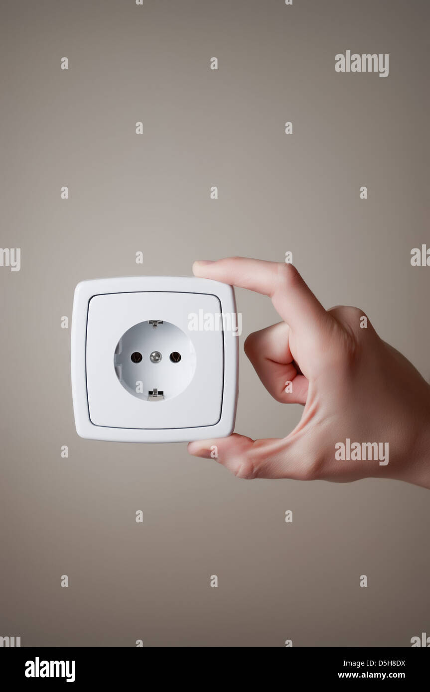 Hand with electric outlet Stock Photo - Alamy