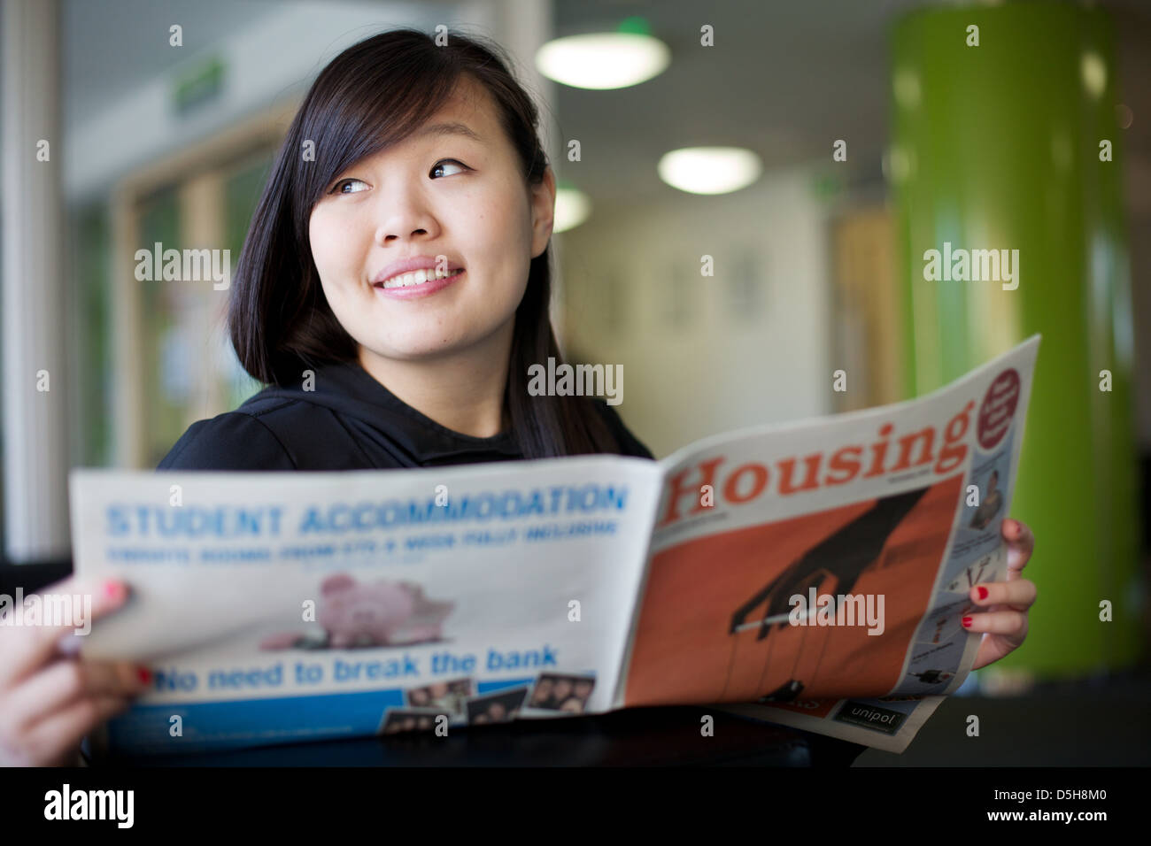 student reading housing magazine Stock Photo - Alamy