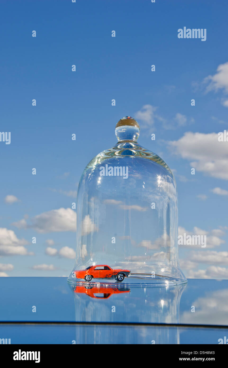 red car toy on mirror in space and glass bell Stock Photo - Alamy