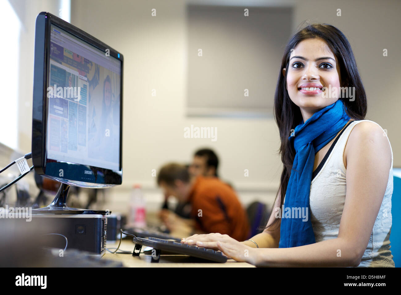 female student on computer looking at camera Stock Photo - Alamy