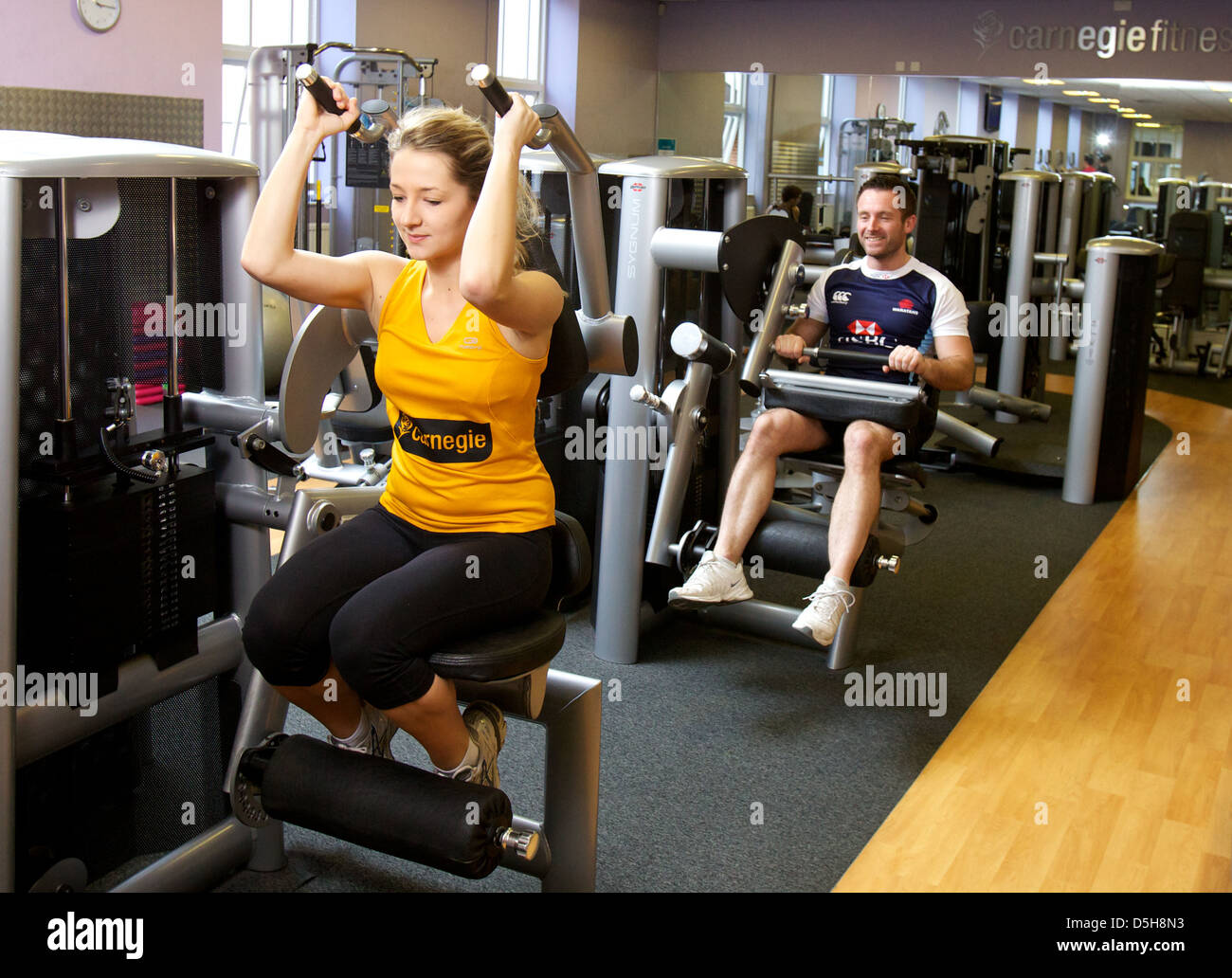 people in gym using equipment Stock Photo - Alamy