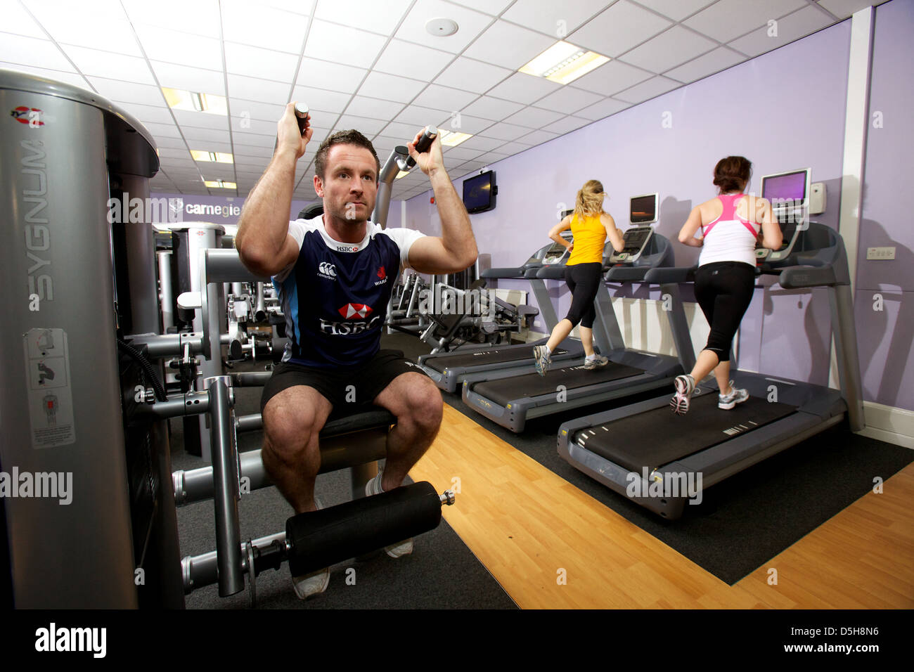 people in gym using equipment Stock Photo - Alamy