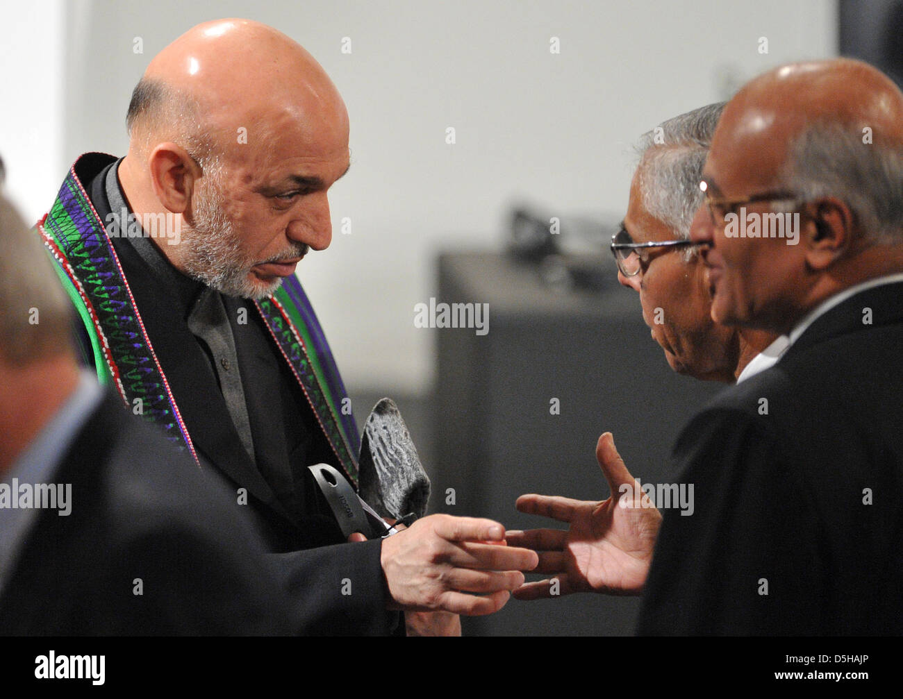 Afghan President Hamid Karzai (L) talks to other participants at the ...