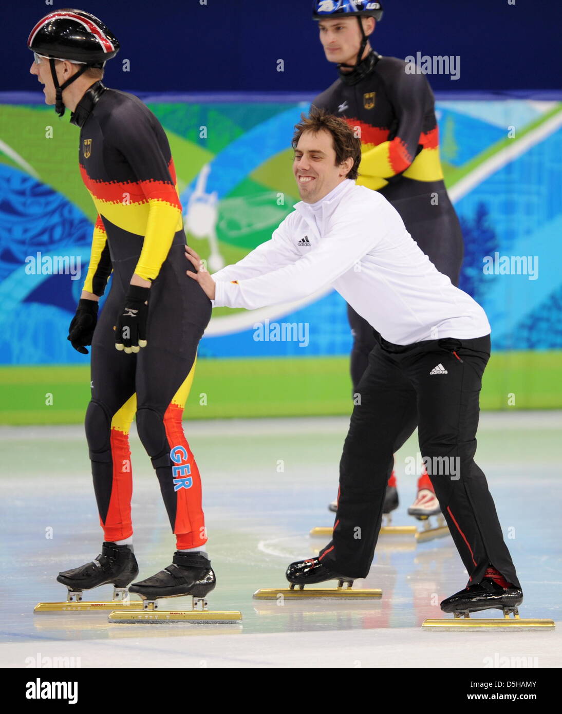 German coach Eric Bedard (R) gives Sebastian Praus a push during the ...