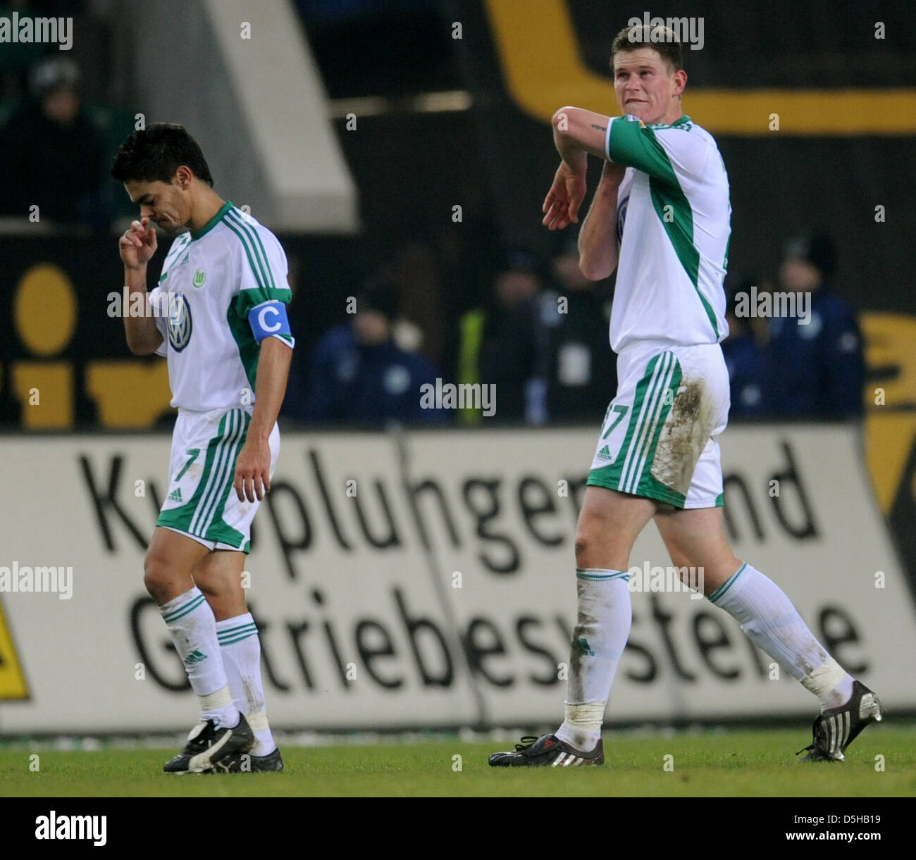 Wolfsburg's Josue (L) and Alexander Madlungleave the pitch after the ...