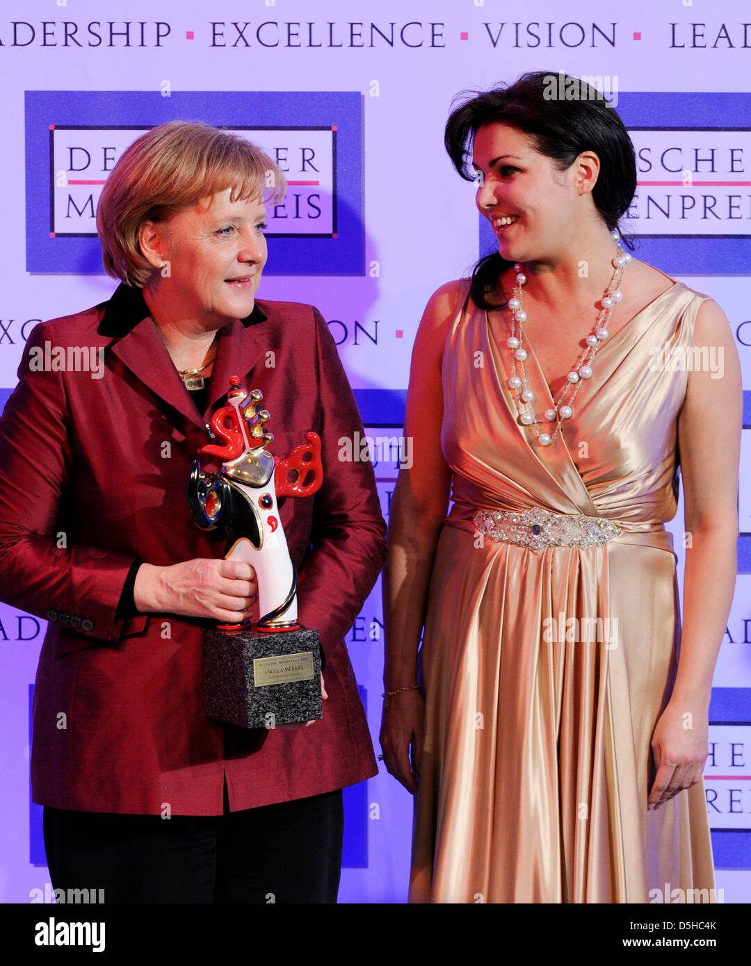 German Chancellor Angela Merkel (L) is honoured with the German Media ...