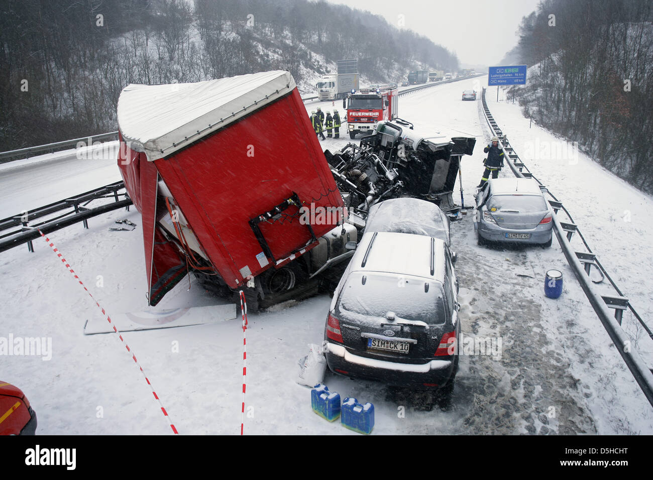 Firemen examine the scene of a lorry accident on the German highway A61 ...