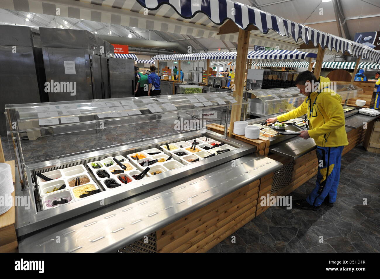 An man helps himself at a self-service counter at the canteen for ...