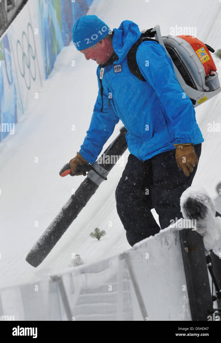 A Worker shovels snow out of the inrun during the Nordic Combined ski ...