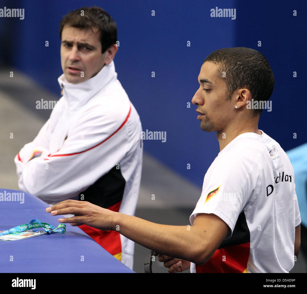 Pairs skater Robin Szolkowy of Germany next to his coach Ingo Steuer (L ...