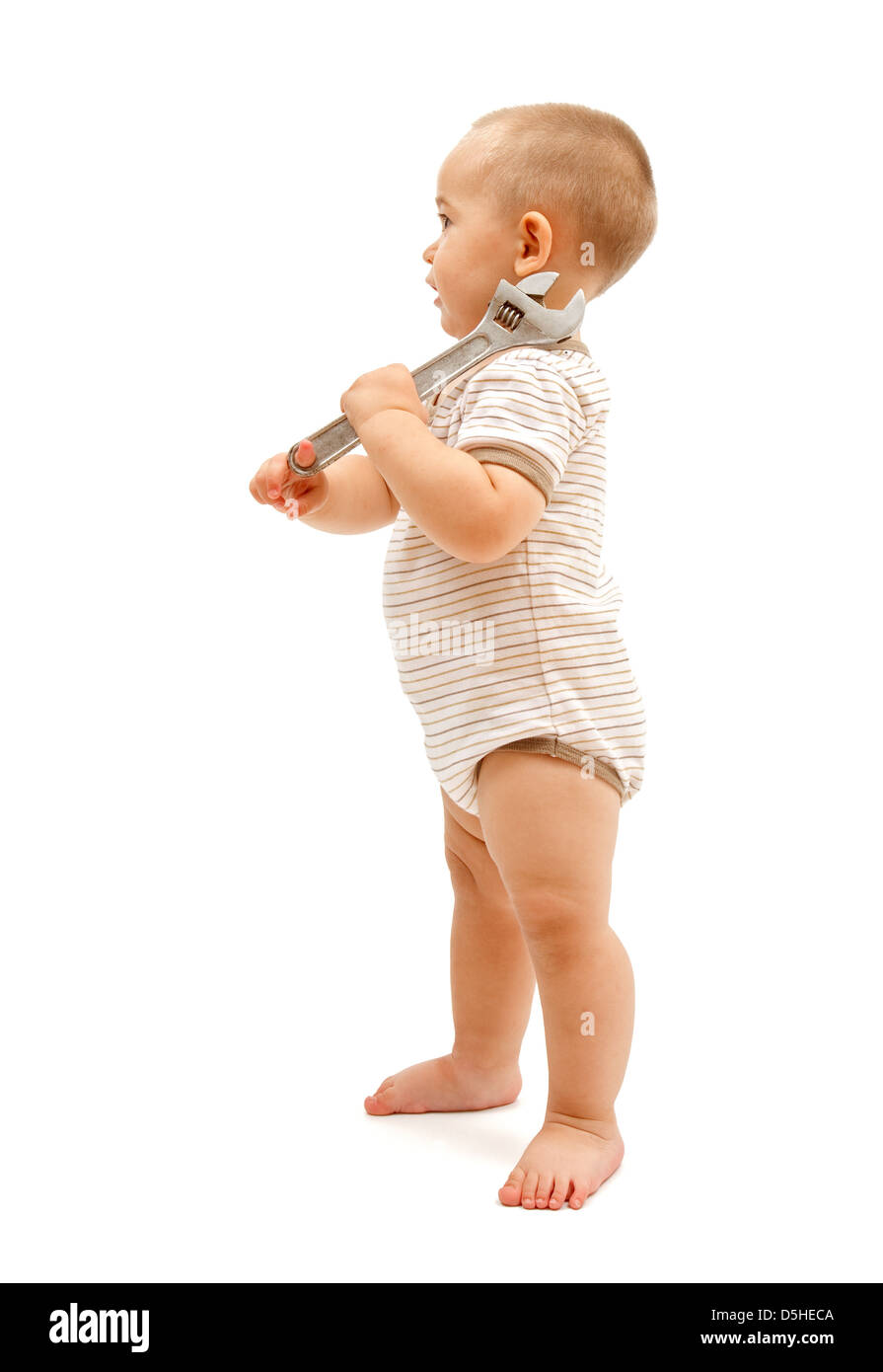 Little boy carrying a big, adjustable wrench on his shoulder. Isolated ...