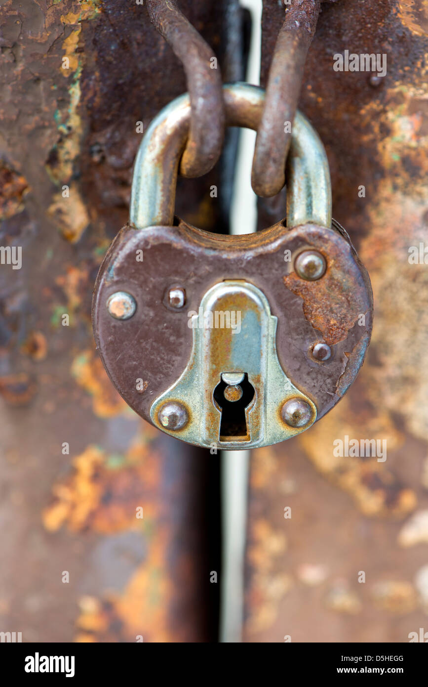 old, damaged padlock - closeup of a closed padlock Stock Photo - Alamy