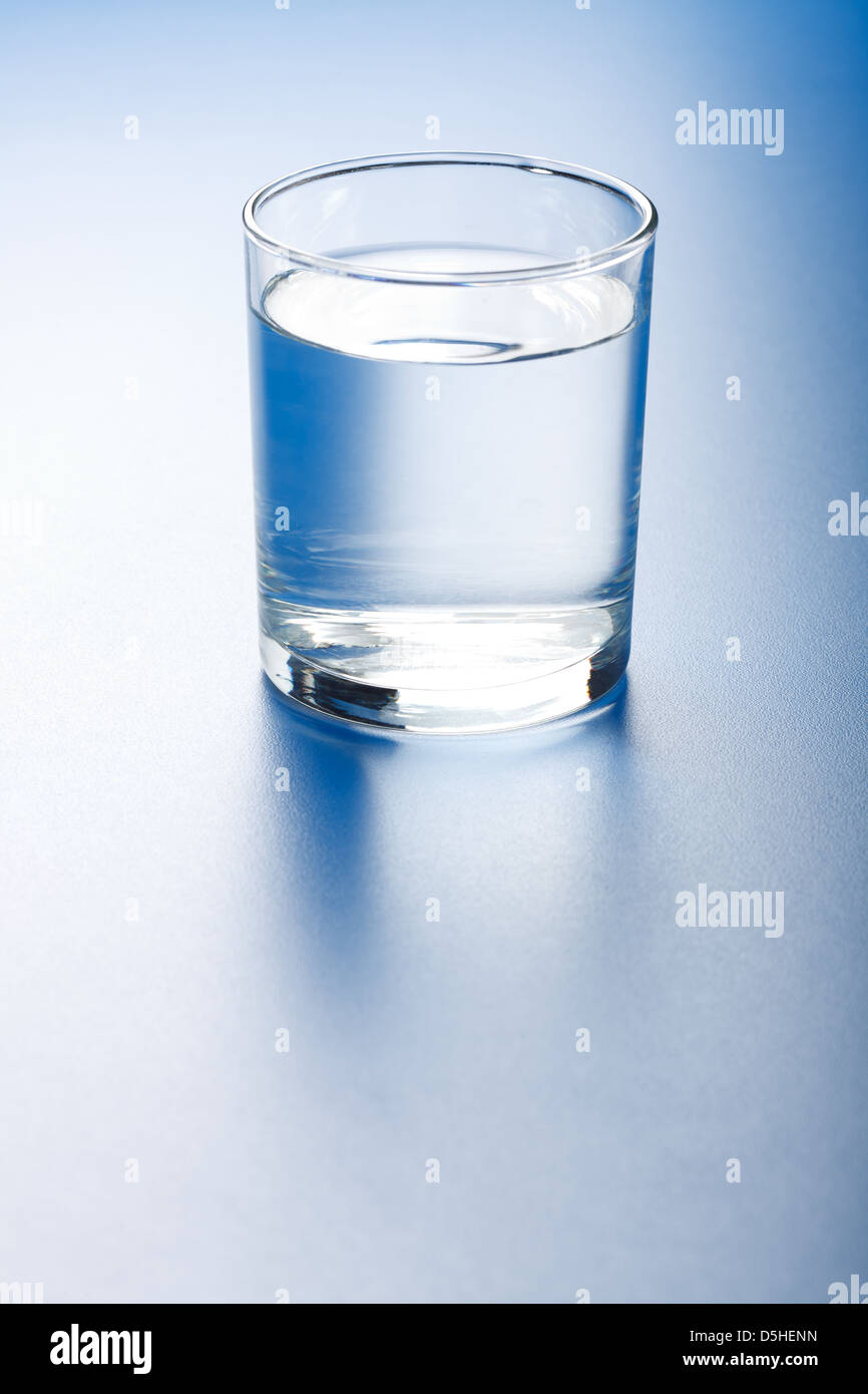 Glass of fresh, clean water on blue Stock Photo - Alamy