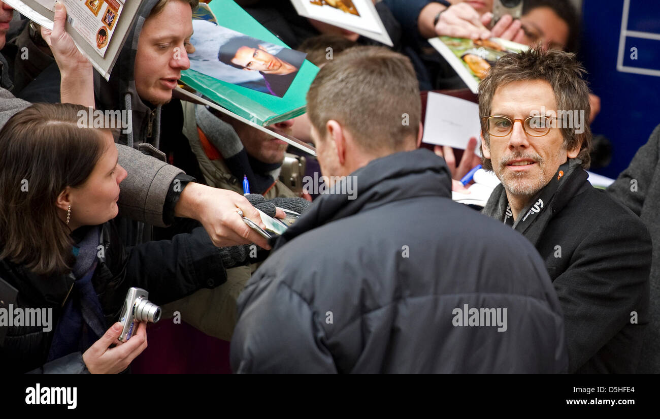US actor Ben Stiller sings autographs as he arrives for the photocall ...