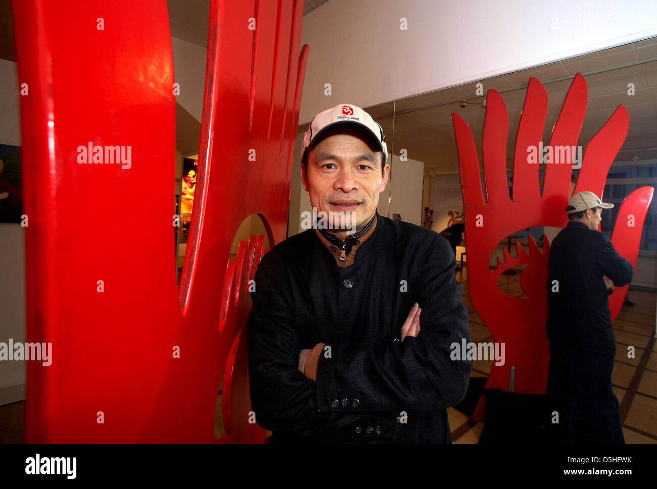 Chinese artist Ren Rong poses next to his sculpture 'Augenhand ...