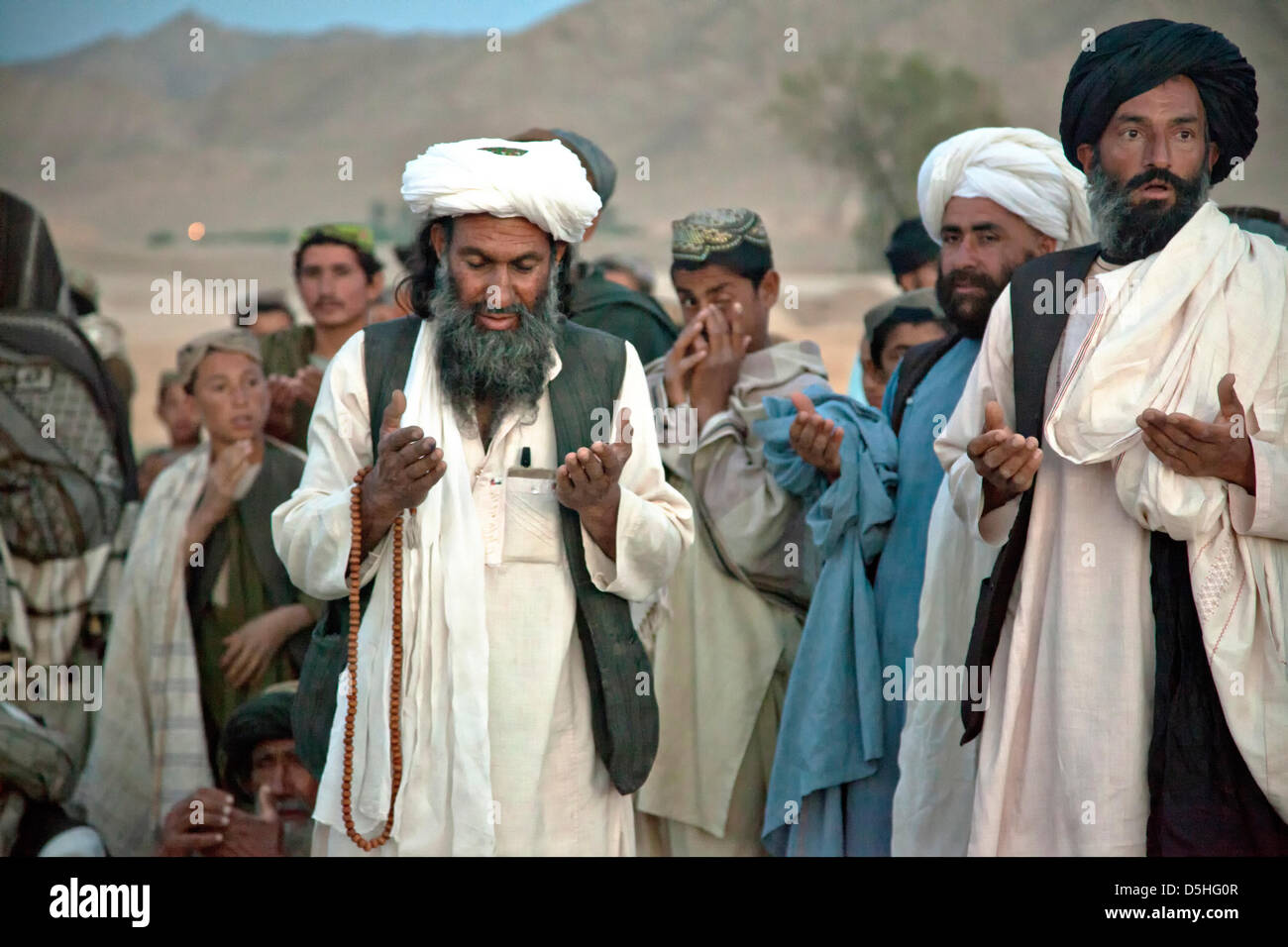 An Afghan elder leads prayers during a shura meeting held by an ALP ...