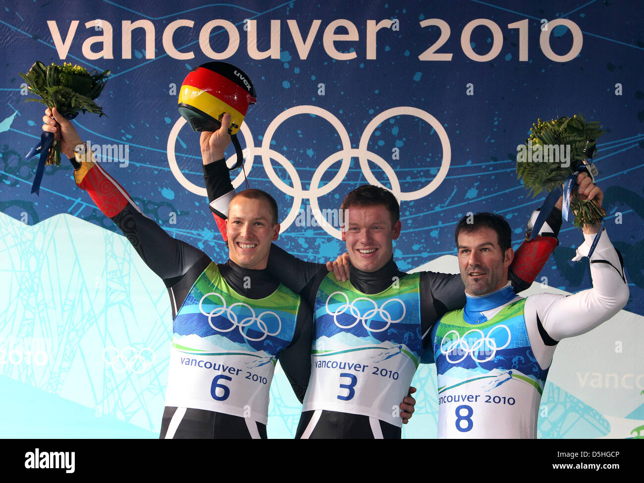 Felix Loch (C) of Germany celebrates after winning the men's Luge ...